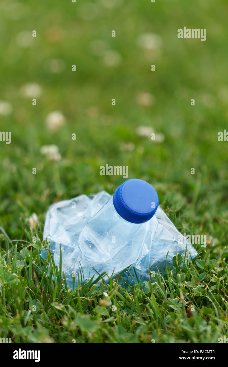 plastic water bottle compressed with hands Stock Photo - Alamy