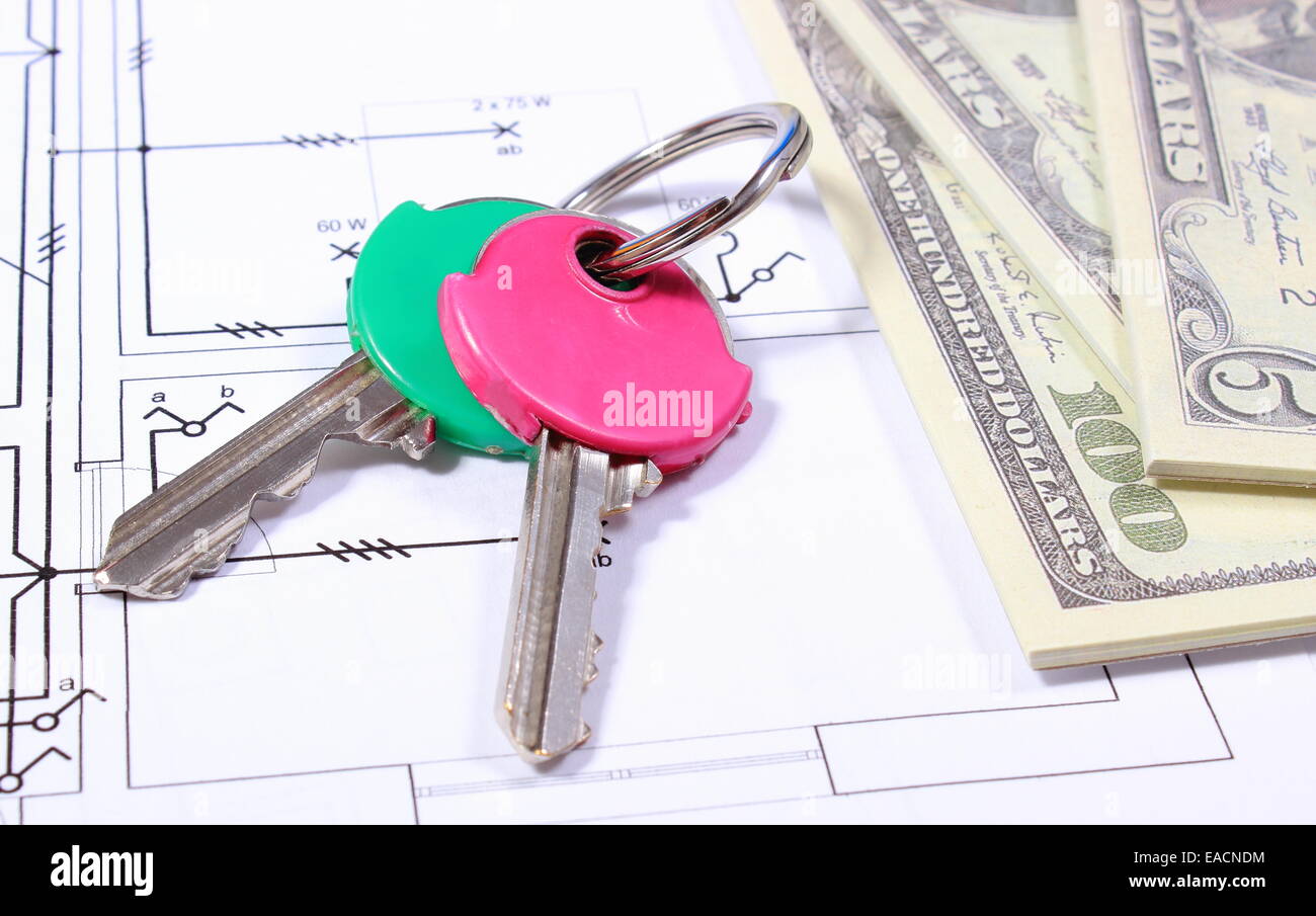 Heap of banknotes and home keys lying on electrical construction ...