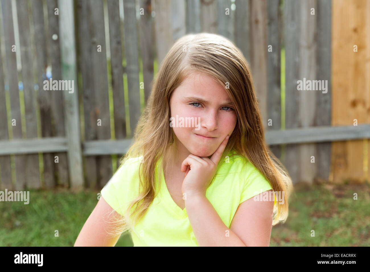kid girl with disappoint expression finger thinking expression outdoor ...