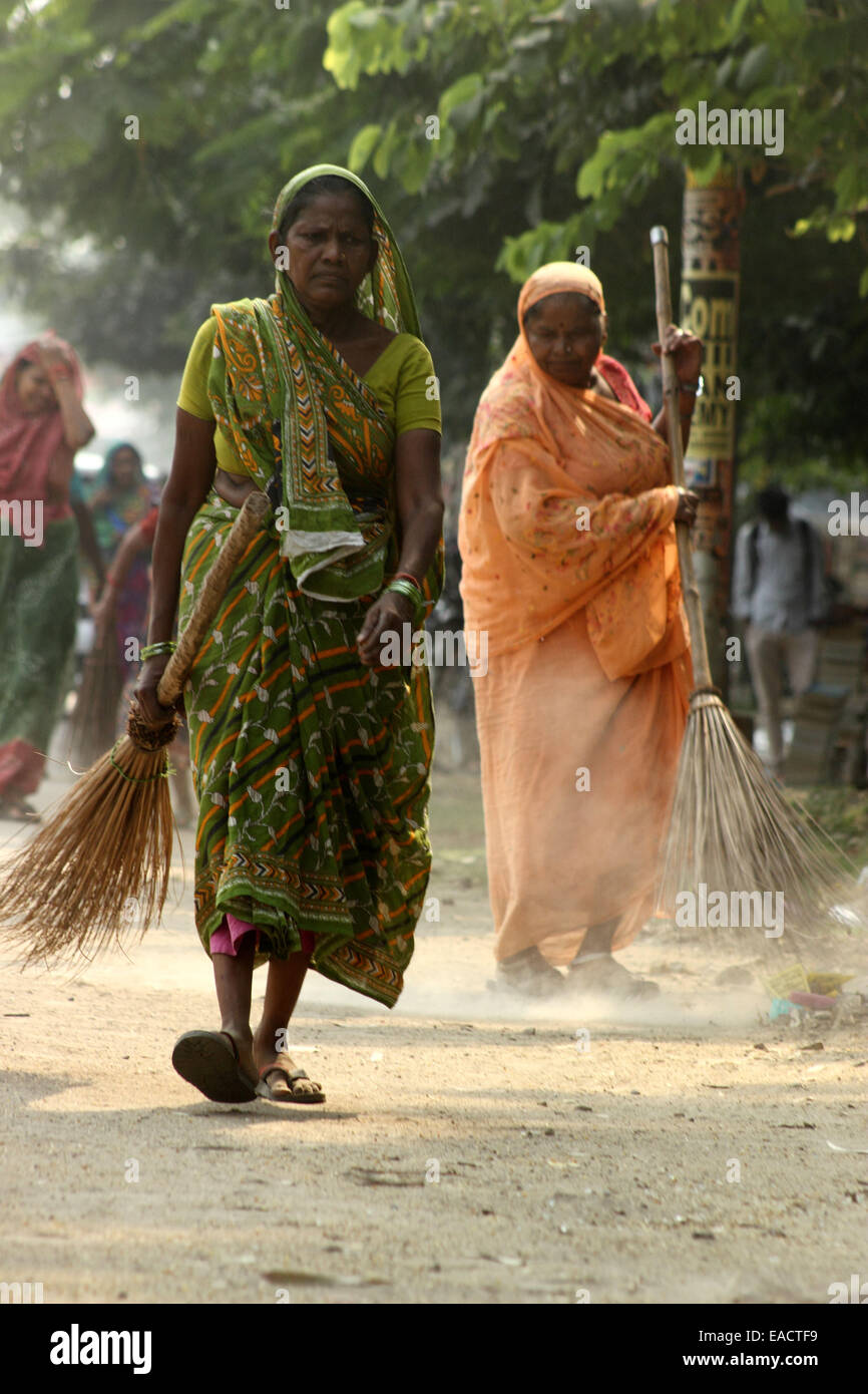 Sweepers (Safai Karmchari) surrounded by dust cleaning the streets of ...