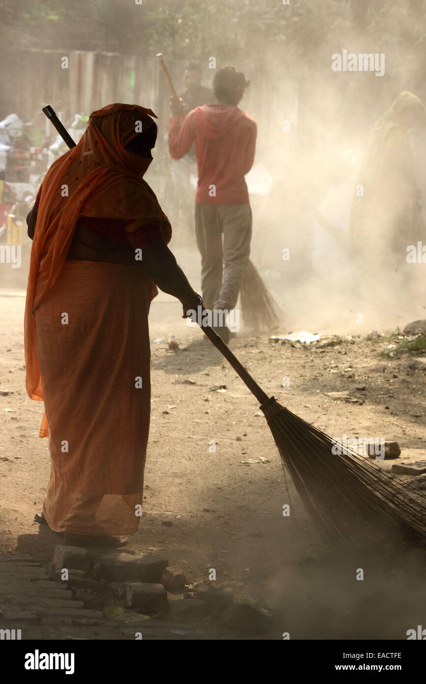 Sweeper (Safai Karmchari) surrounded by dust cleaning the streets of ...