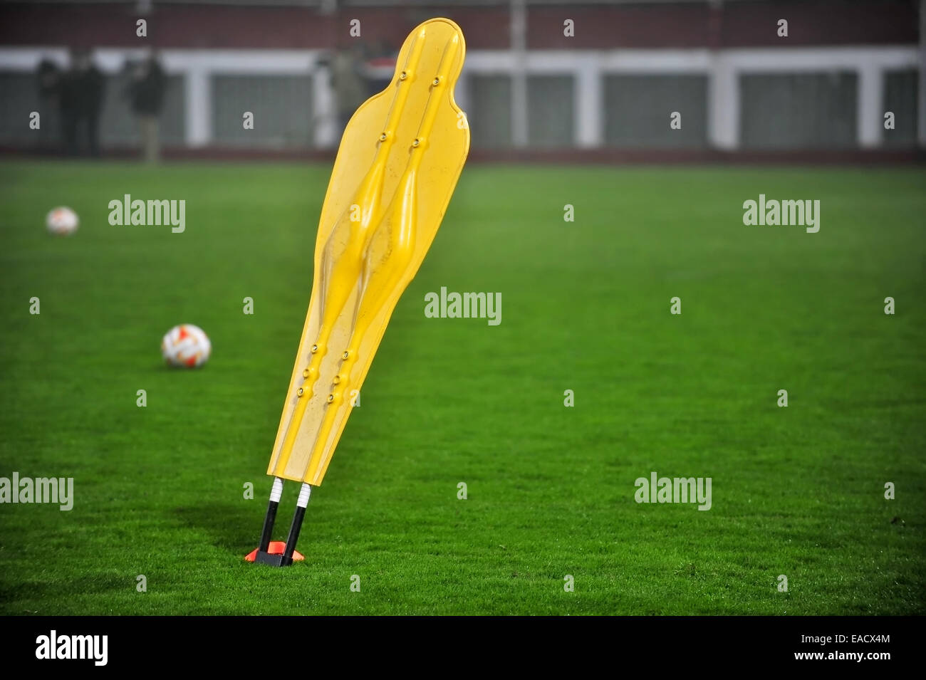 One yellow soccer training dummy on the field Stock Photo - Alamy