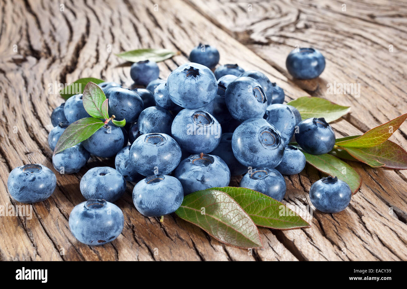 Blueberries over old wooden table Stock Photo - Alamy