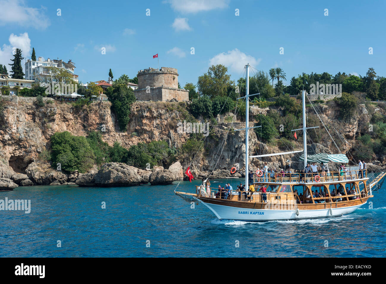 Excursion boat in the Gulf of Antalya, cliffs with Hıdırlık tower ...