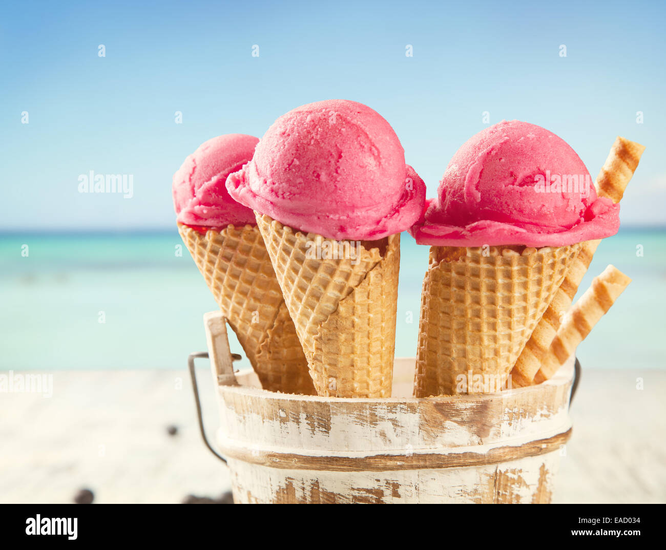 Fruit ice cream with blur beach as background. Served on wooden planks ...
