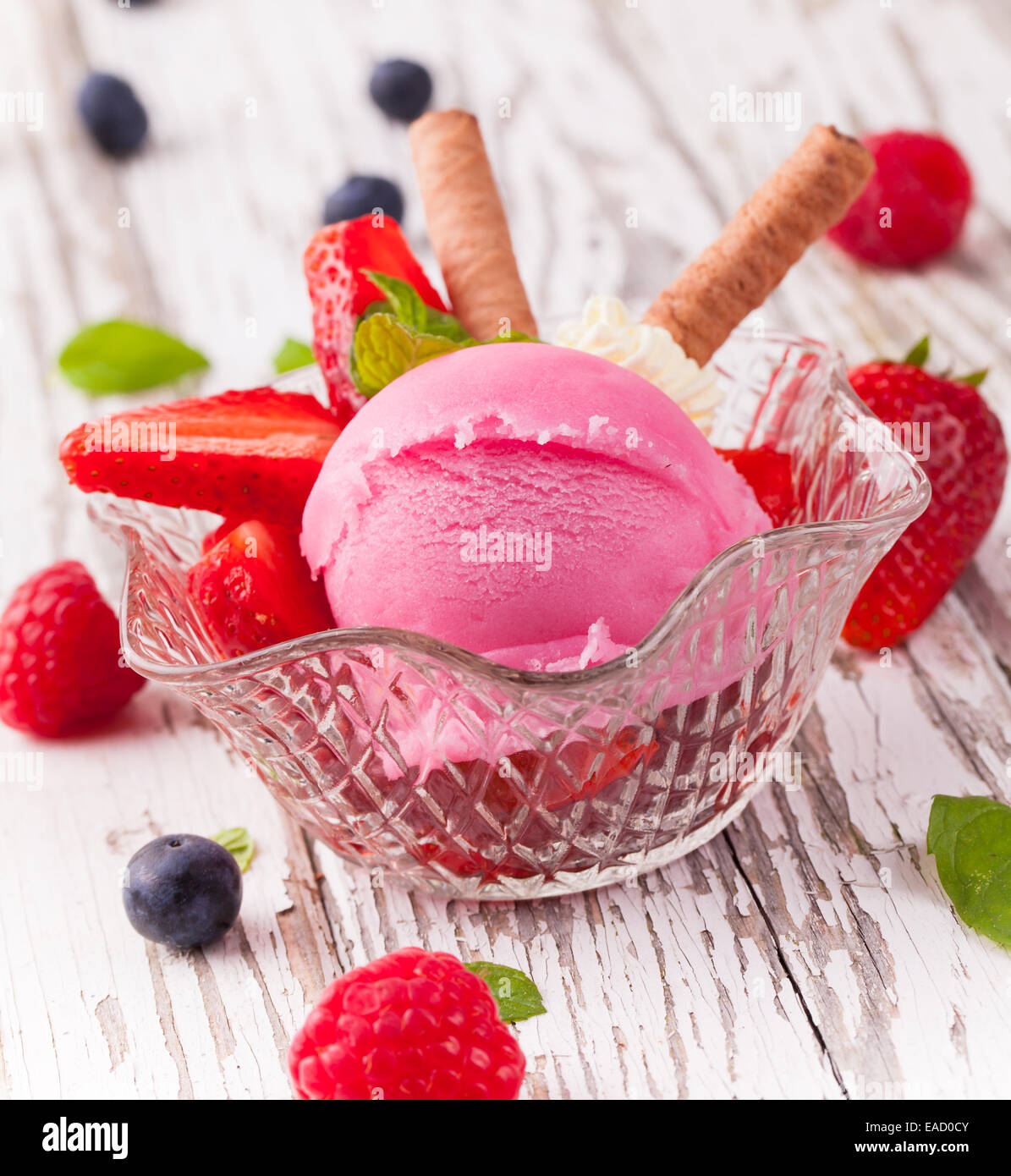 Strawberry ice cream in sundae on wooden table Stock Photo - Alamy