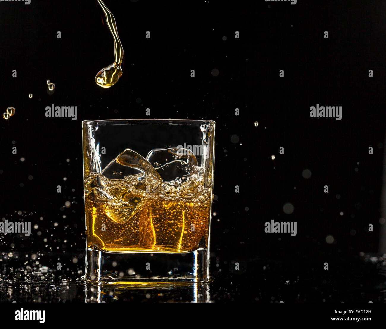Pouring whiskey into glass, isolated on black background Stock Photo ...