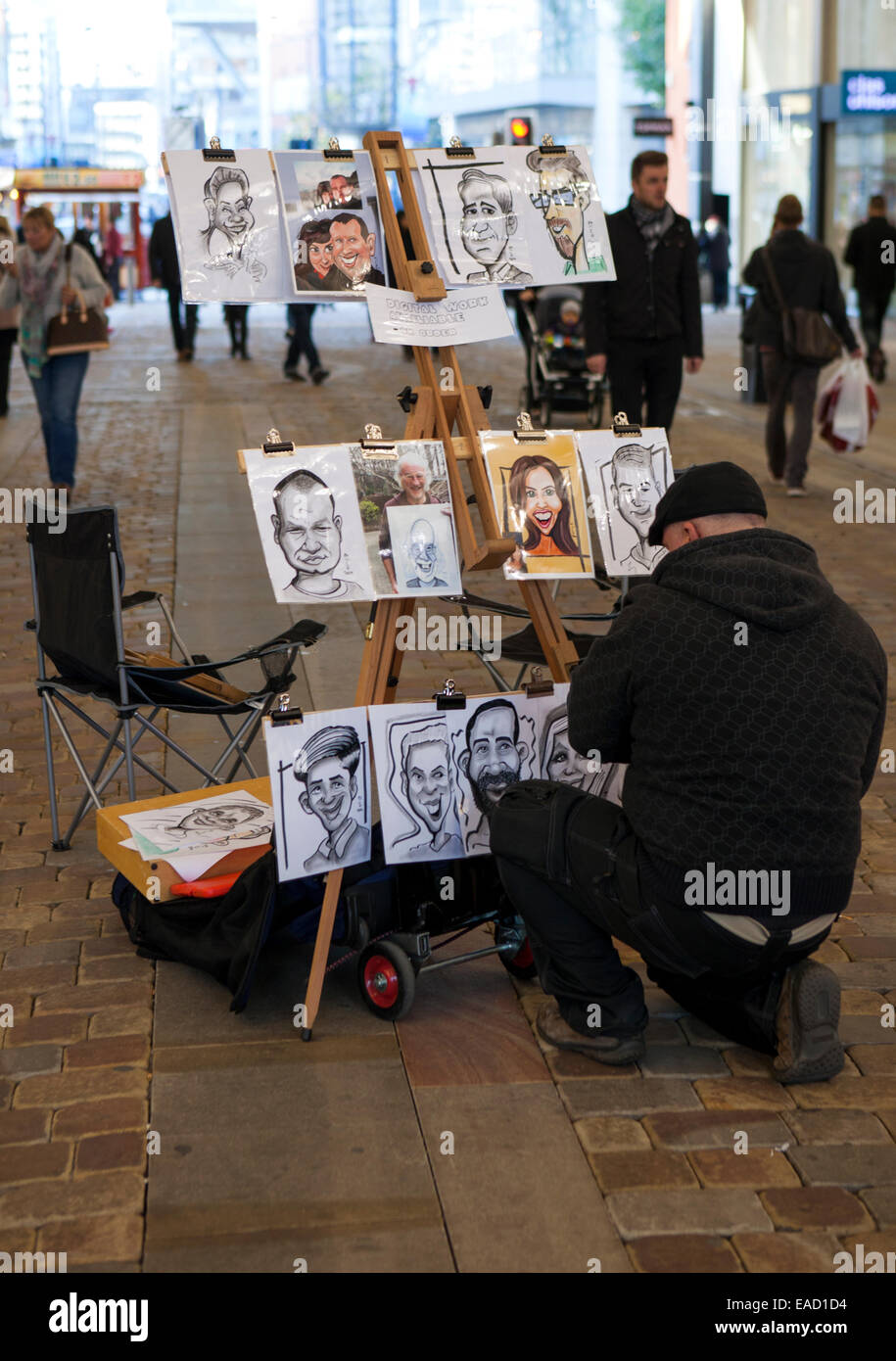 Caricature artist showing his paintings on Market Street, Manchester ...