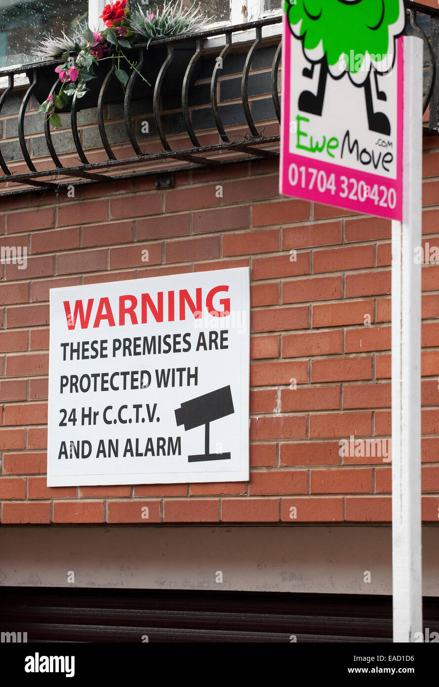 House for sale with 'Warning 24hr CCTV' sign Stock Photo - Alamy