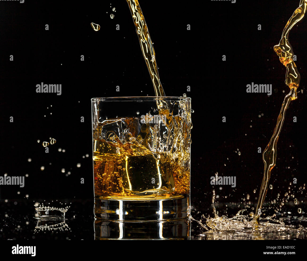 Pouring whiskey into glass, isolated on black background Stock Photo ...