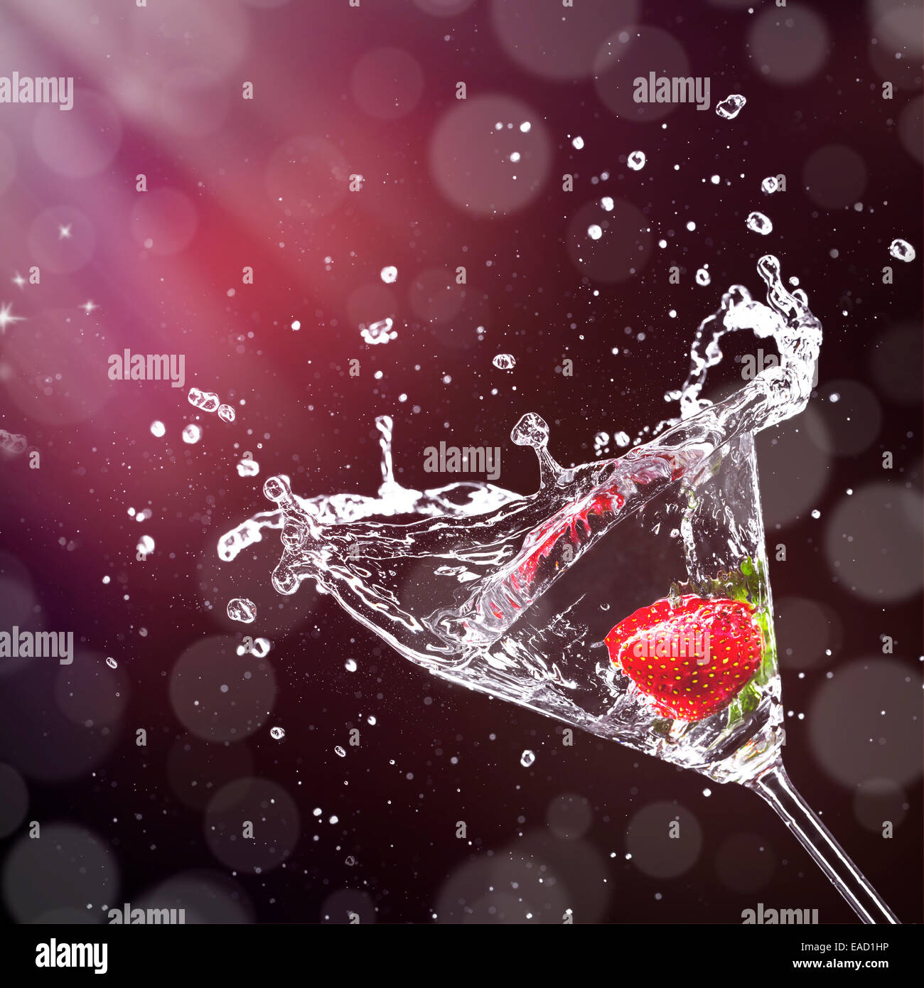Martini drink splashing out of glass Stock Photo - Alamy