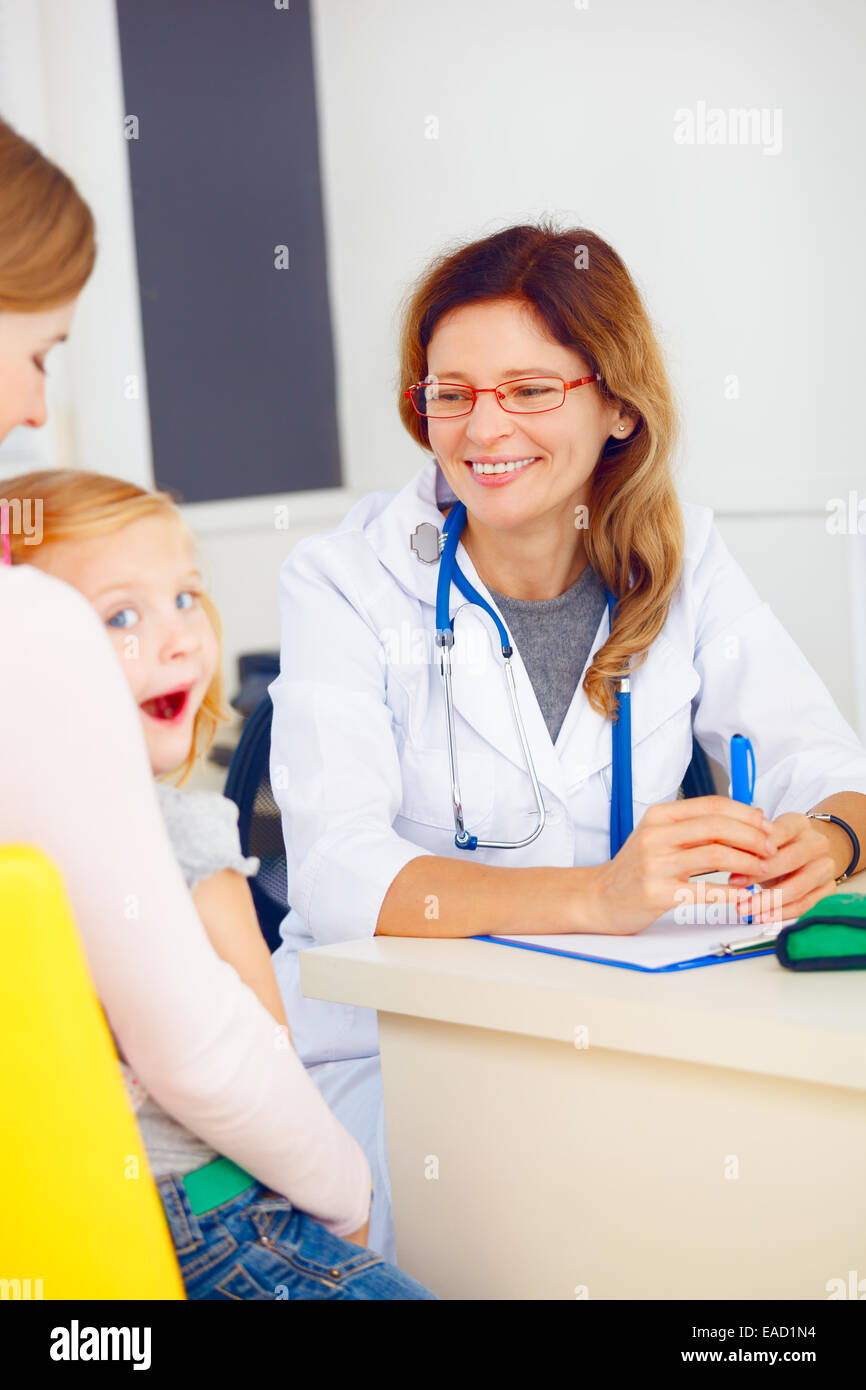 Visit to pediatrician. Happy child with her mother visiting doctor ...