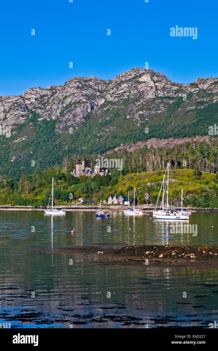 View across yachts anchored in Plockton harbour to Duncraig Castle ...