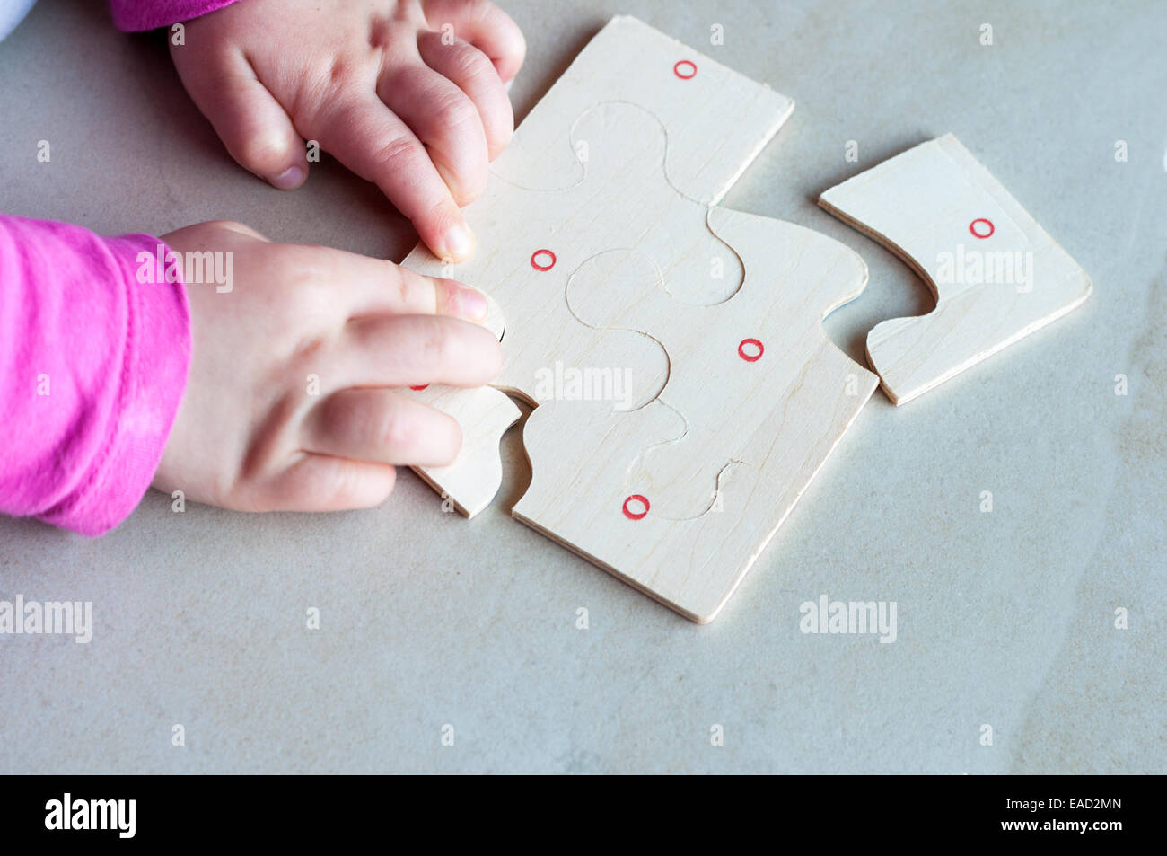 Little child solving a puzzle Stock Photo - Alamy