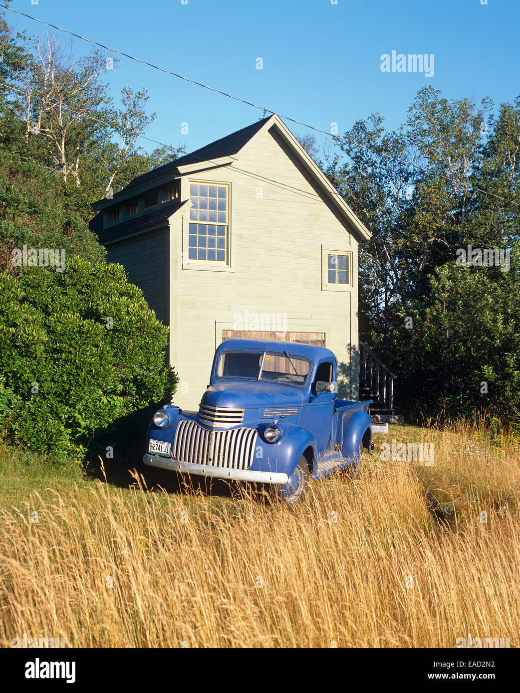 antique blue pick up truck in front of contemporary wood building Stock ...