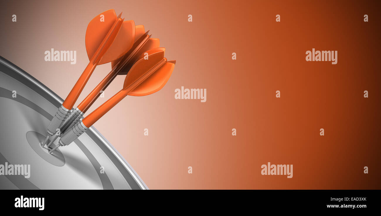 Three darts hitting the center of a target over orange background ...