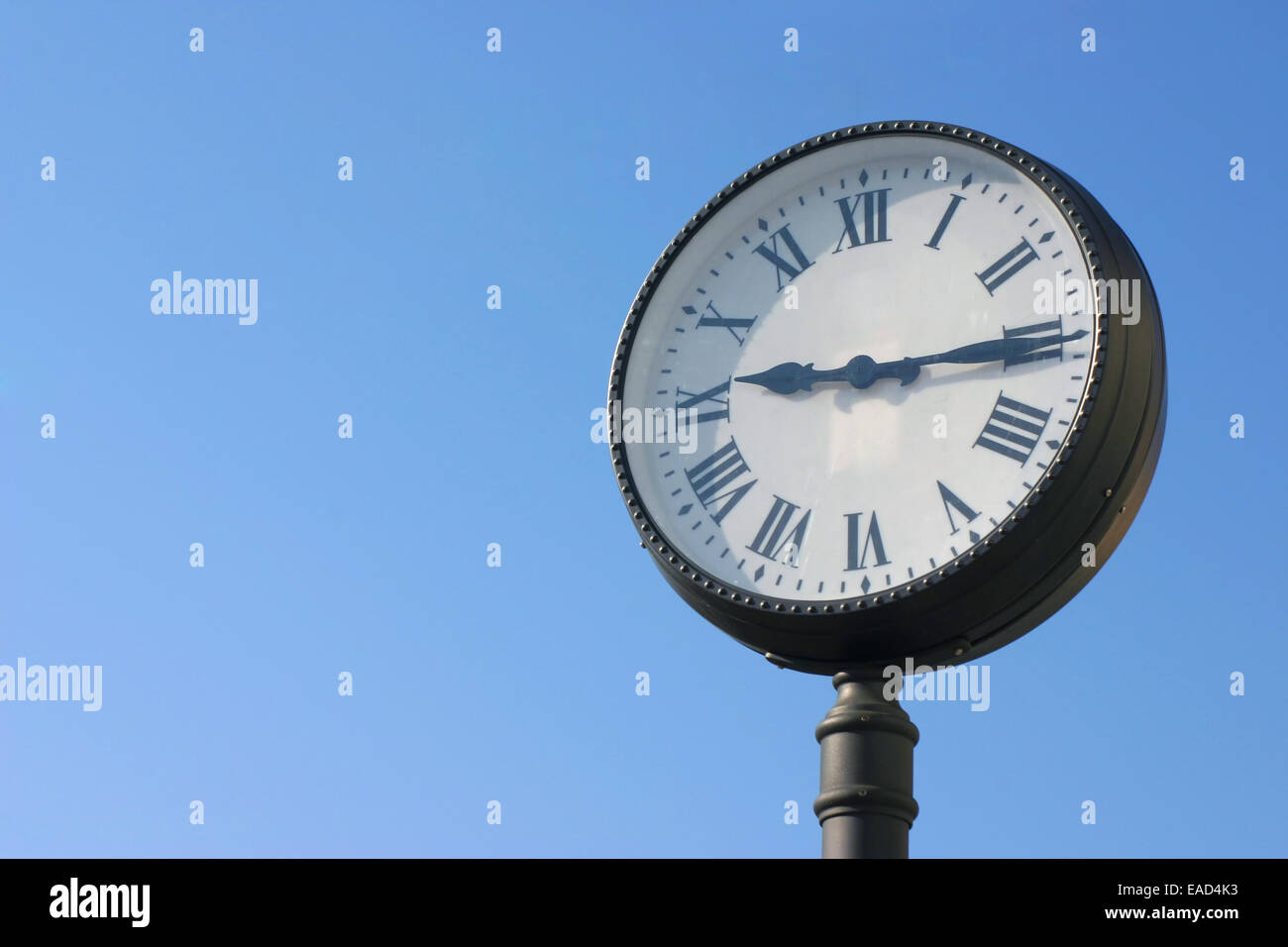 Street clock against blue sky with copy space Stock Photo - Alamy