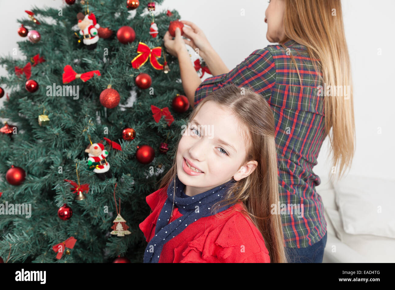 Girl beside the christmas tree Stock Photo - Alamy