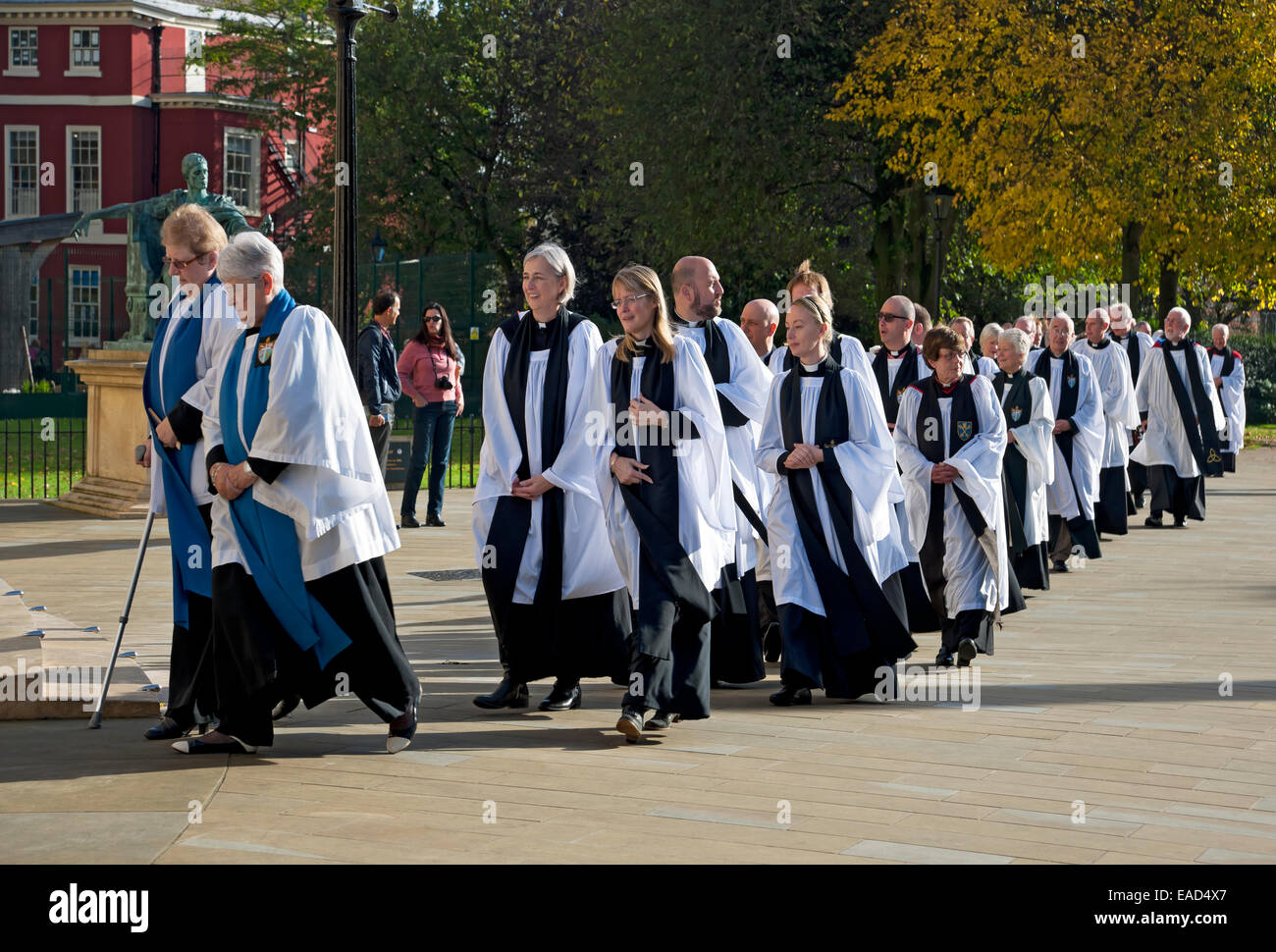 Members of the Christian Anglican clergy clergymen vicars walking to ...