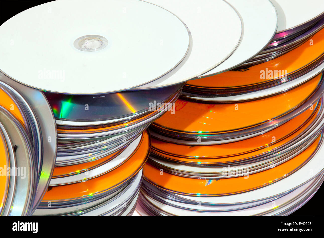 Closeup view of a collection of many colorful stacked compact disks in ...