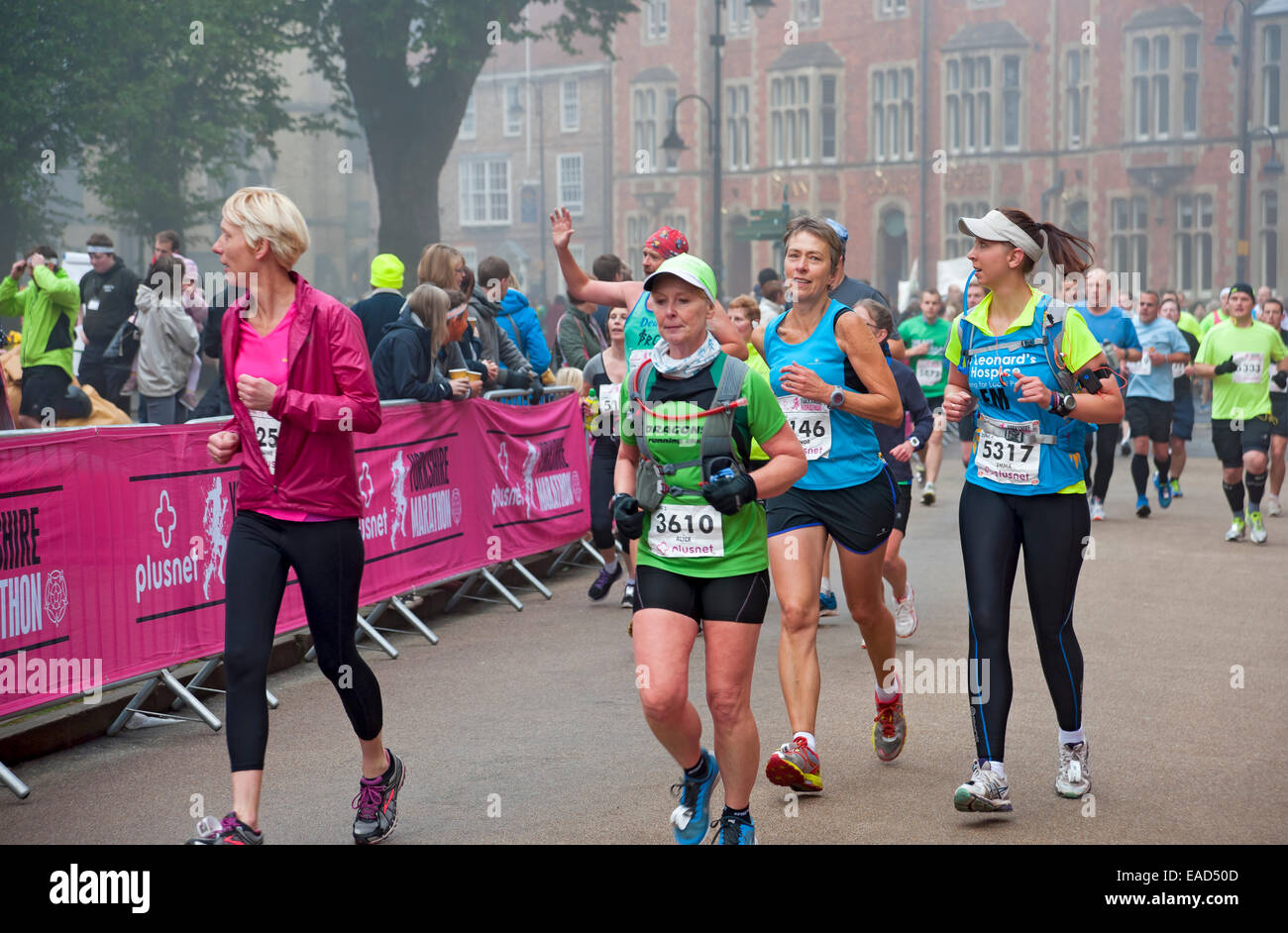 Competitors people women runners running through the city centre in the ...