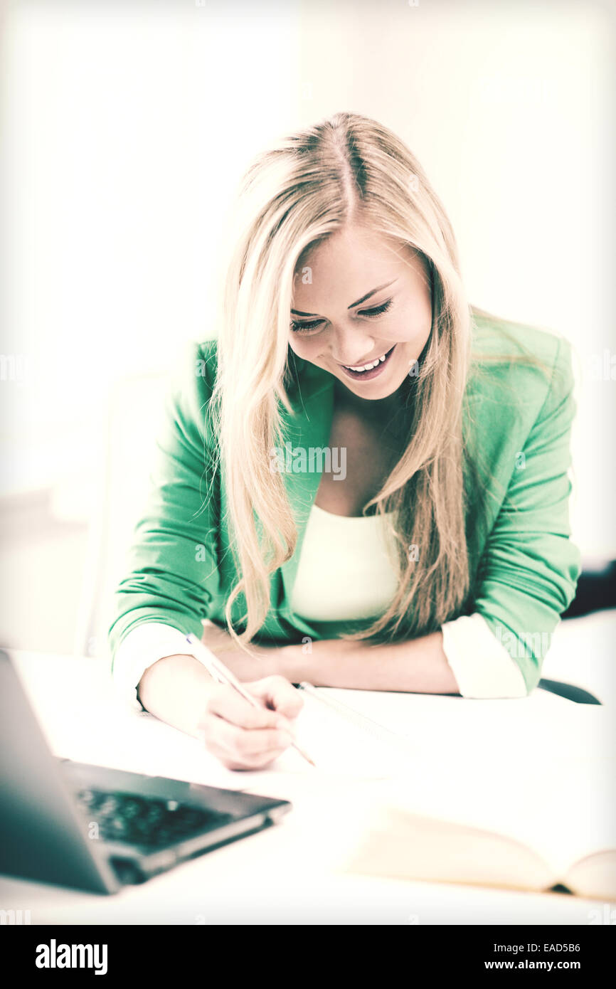 smiling student girl writing in notebook Stock Photo - Alamy