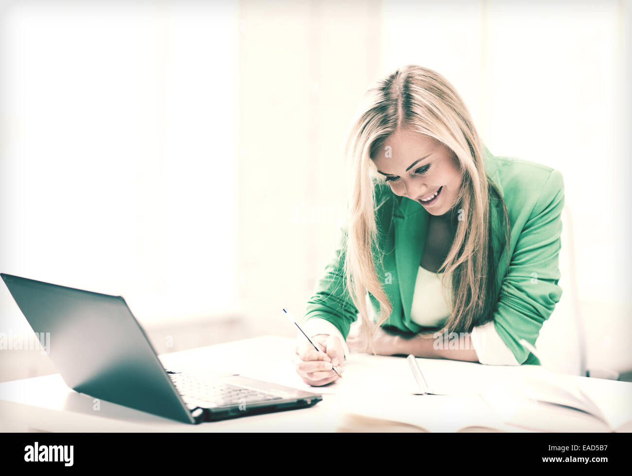 smiling student girl writing in notebook Stock Photo - Alamy