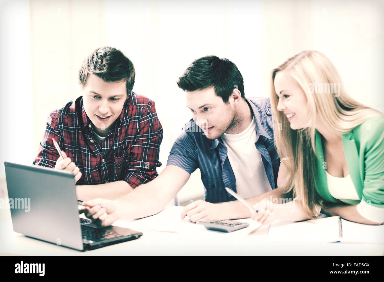 smiling students looking at laptop at school Stock Photo - Alamy