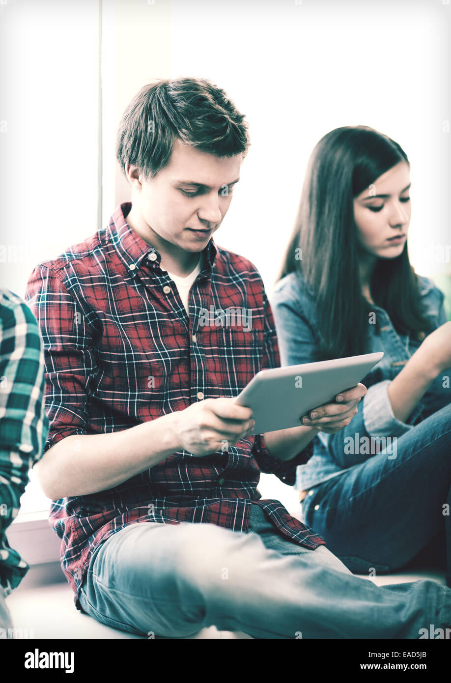 student looking into tablet pc at school Stock Photo - Alamy