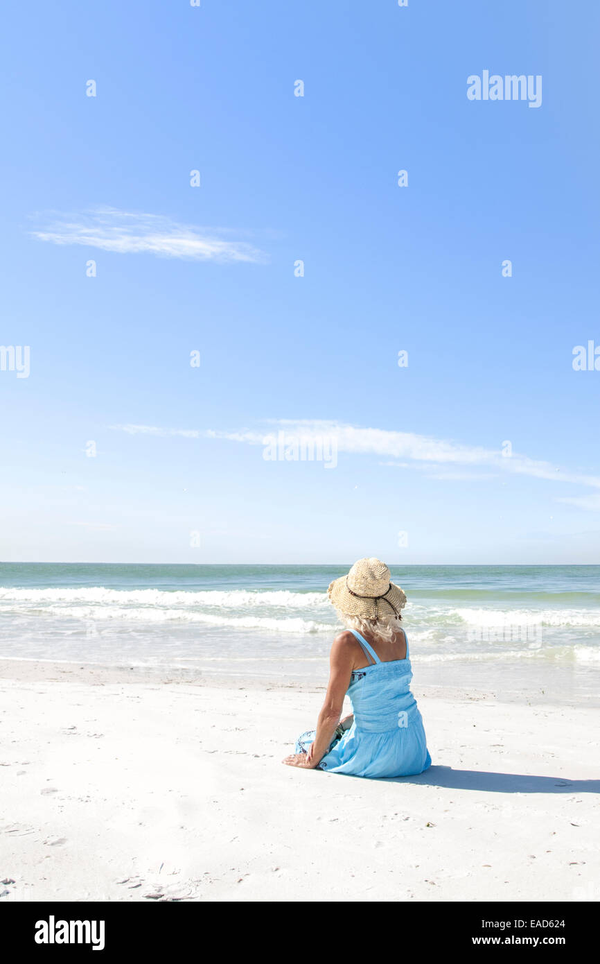 Mature woman sitting on Coquina Beach, Anna Maria Island, Florida Stock ...
