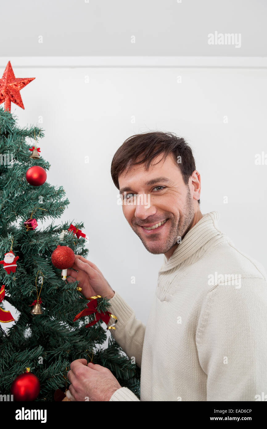 Man beside christmas tree hi-res stock photography and images - Alamy
