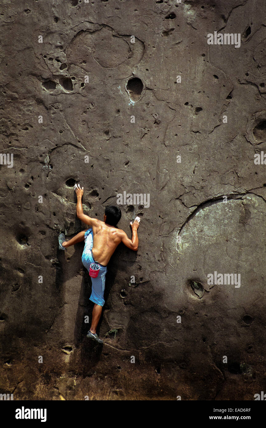 A man bouldering andesite rock at Batu Belang, Purwakarta, Indonesia ...