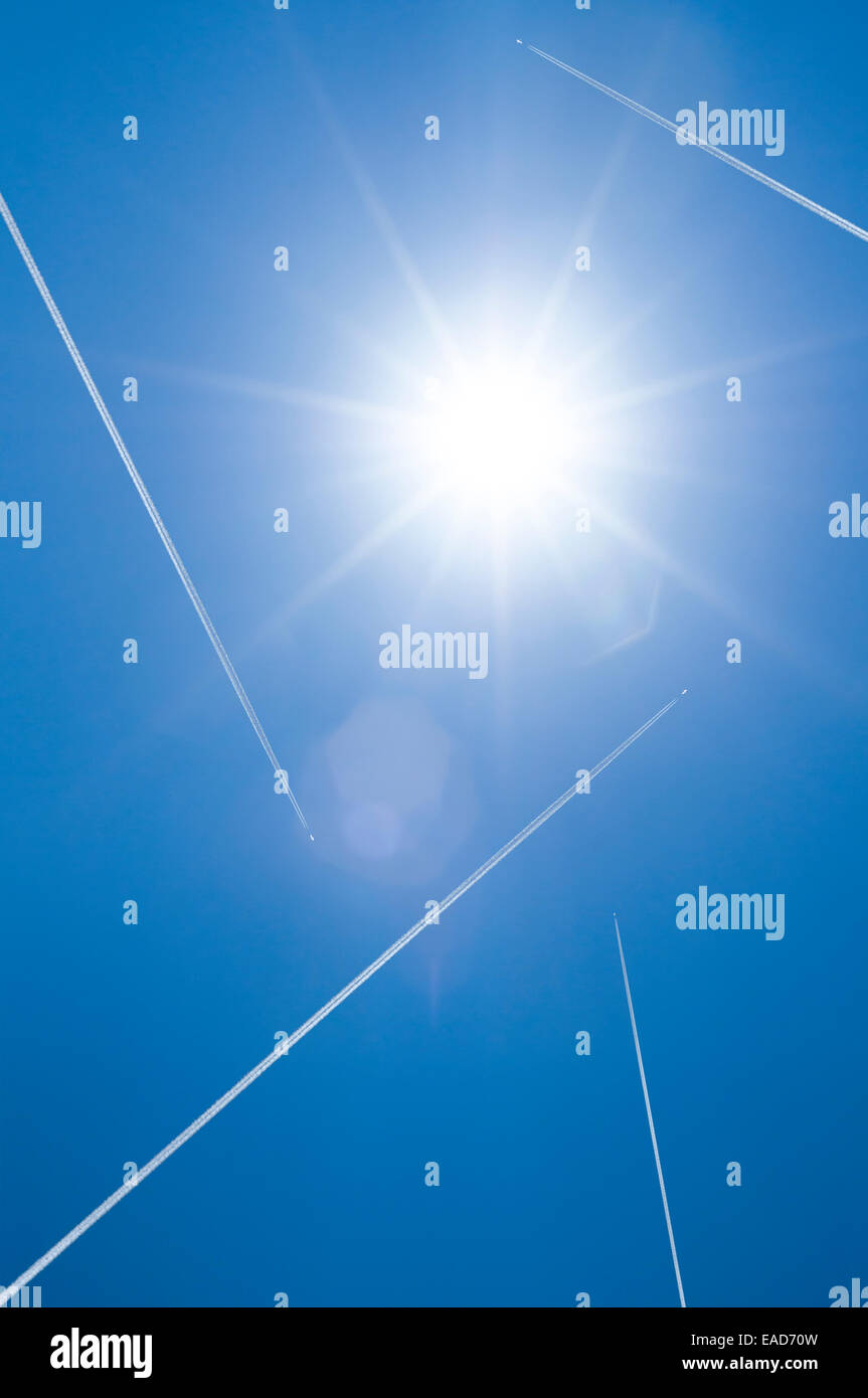 airplanes flying on blue sky with sun Stock Photo - Alamy