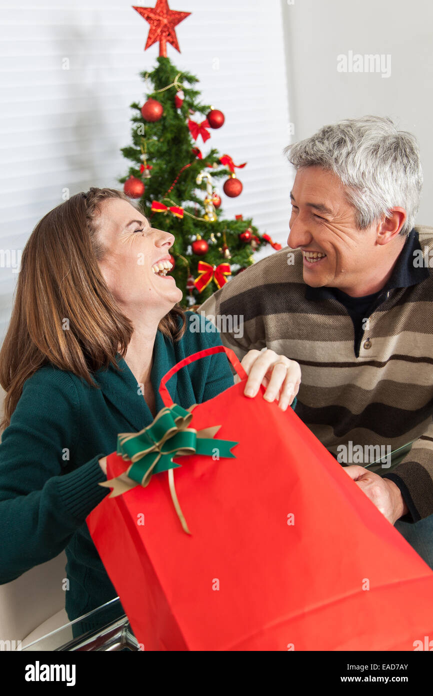 Couple opening the gift and laughing Stock Photo - Alamy
