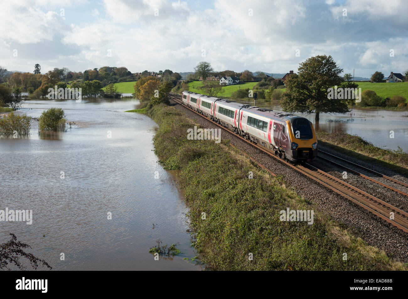 A Cross Country Trains passenger train passes flooded fields near Rewe ...