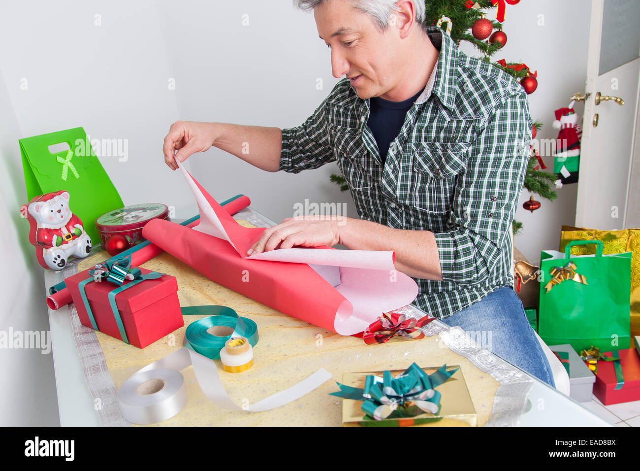 Man wrapping gifts Stock Photo - Alamy