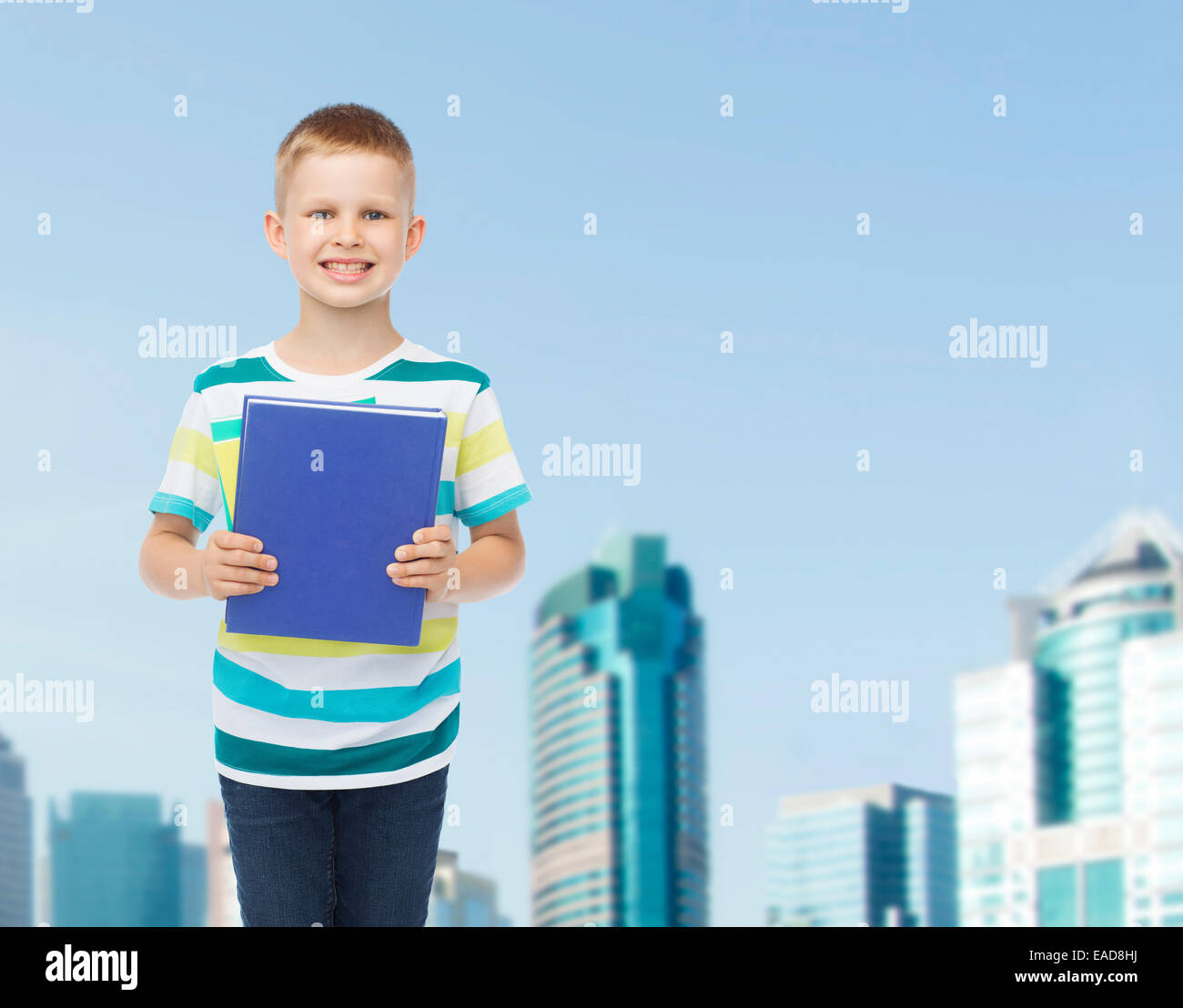 smiling little student boy with blue book Stock Photo - Alamy
