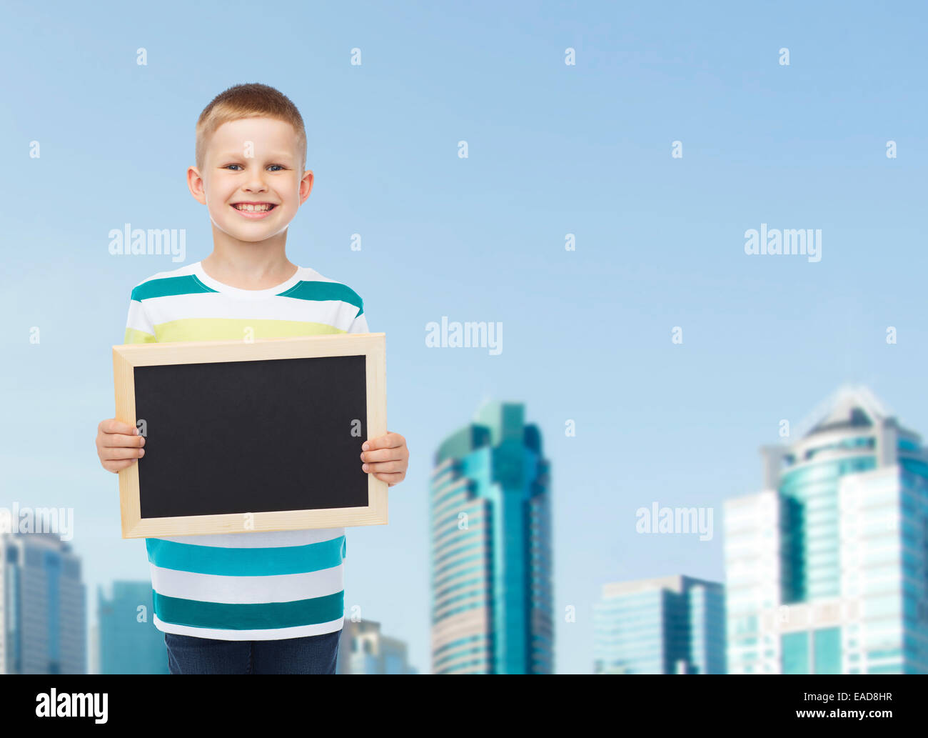smiling little boy holding blank black chalkboard Stock Photo - Alamy