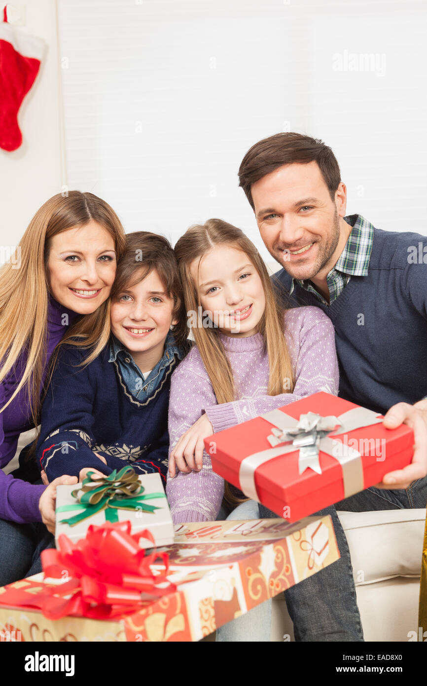 Happy family smiling giving present Stock Photo - Alamy