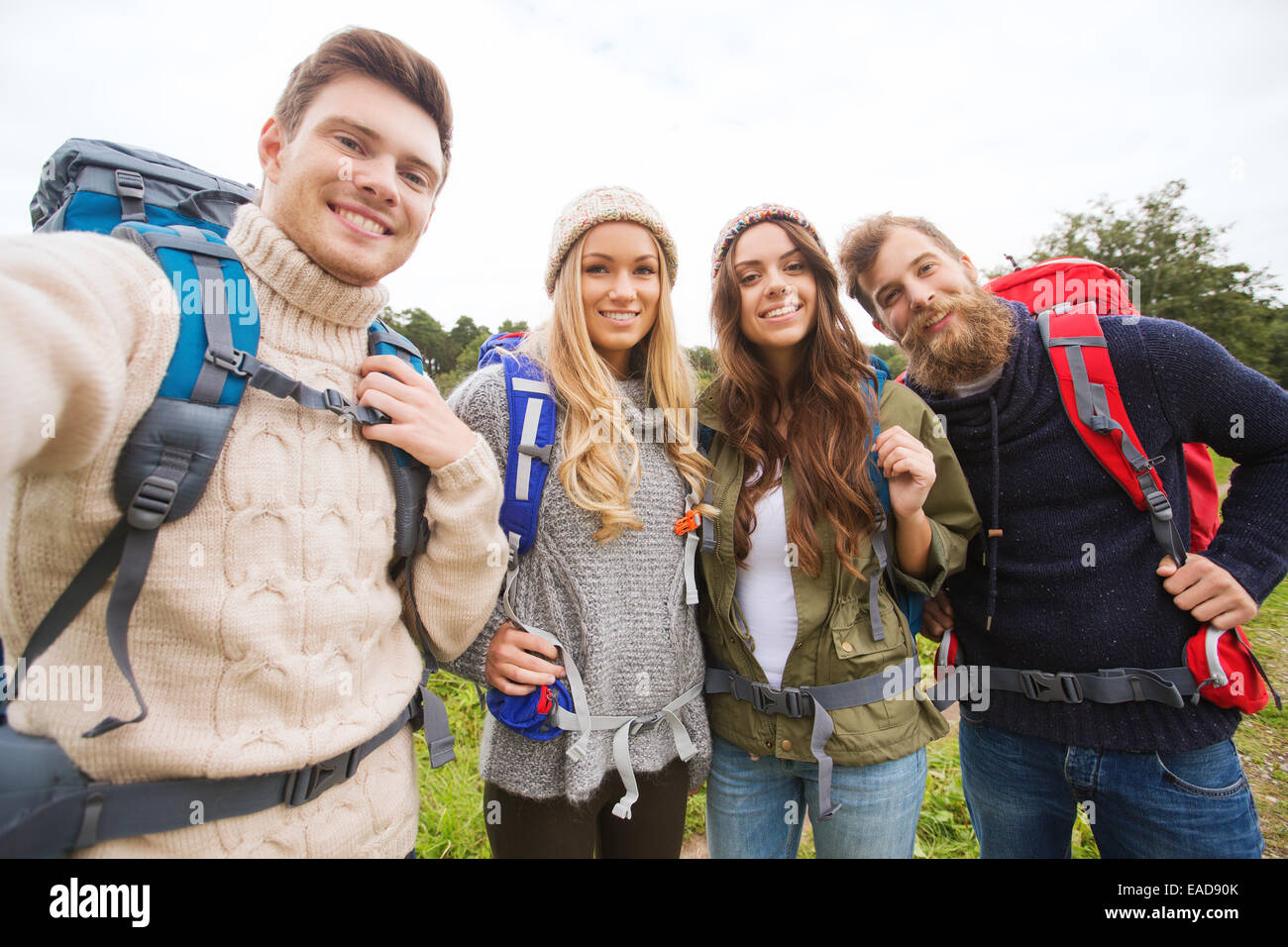 group of smiling friends with backpacks hiking Stock Photo - Alamy