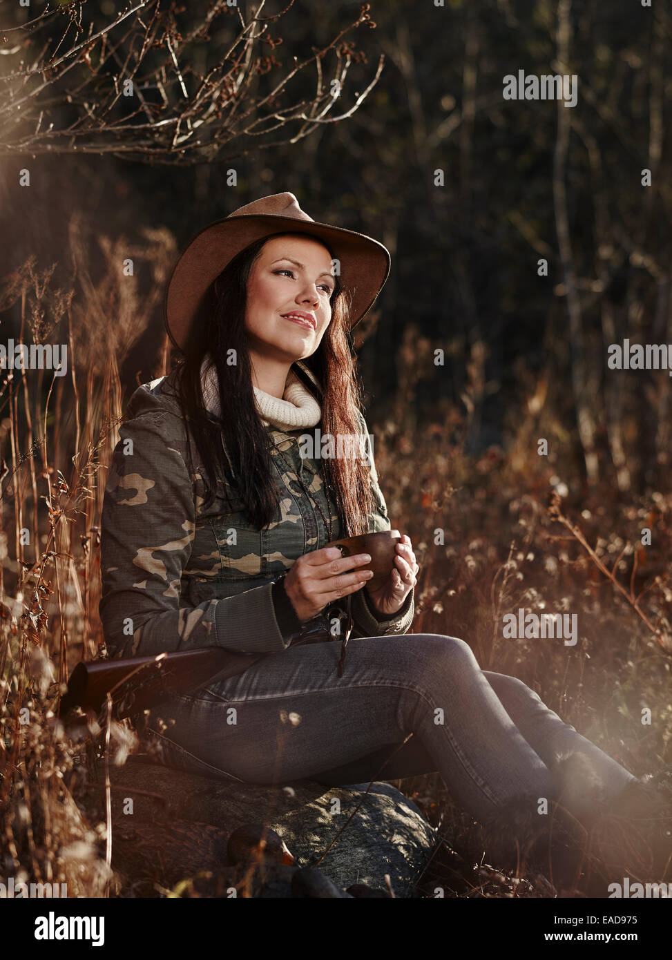 Waterfowl hunting, the female hunter having a coffee break, autumnal ...