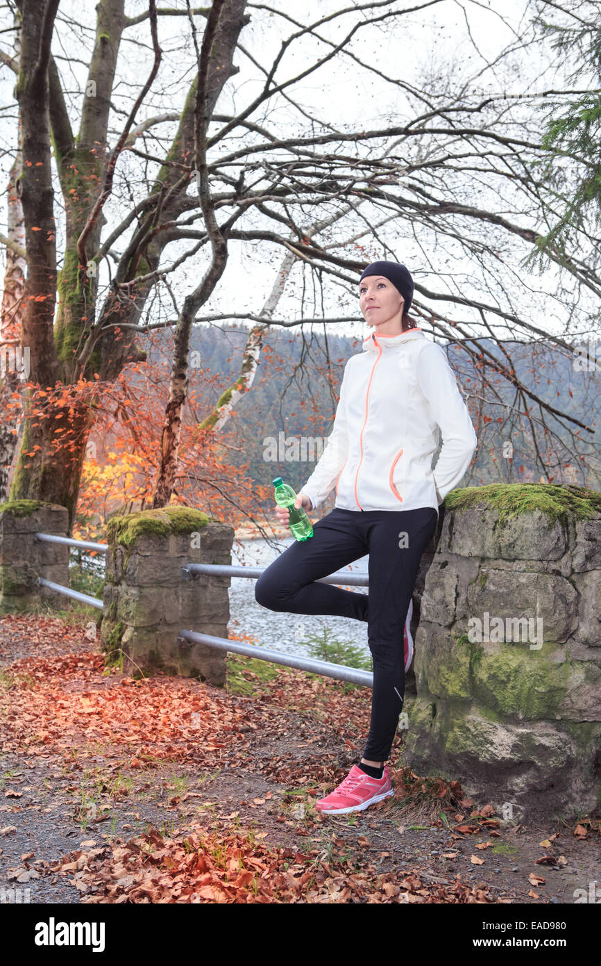 woman running through the forest by the lake Stock Photo - Alamy