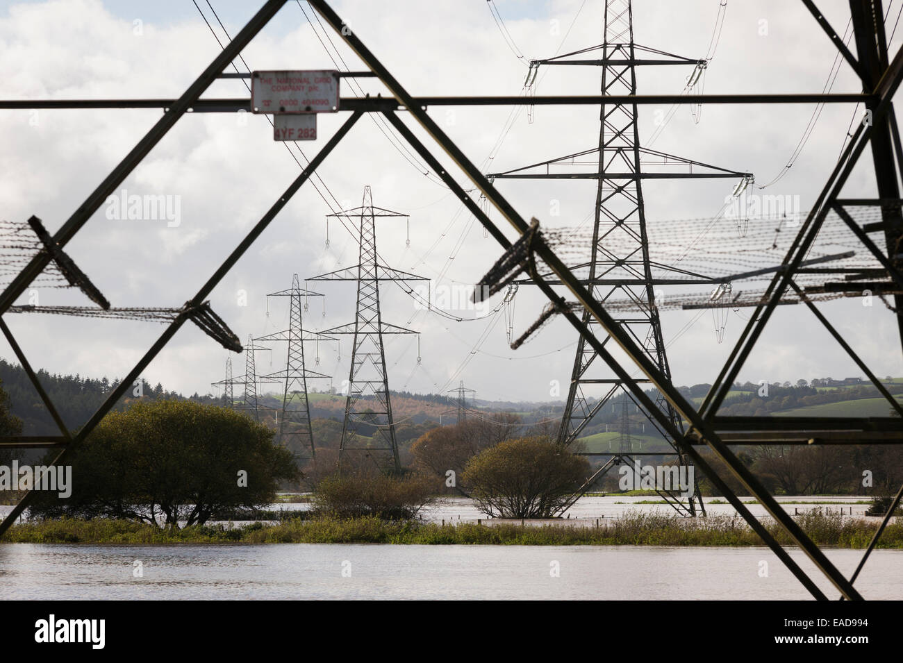 Electricity pylons stand in flood water at Stoke Canon near Exeter ...