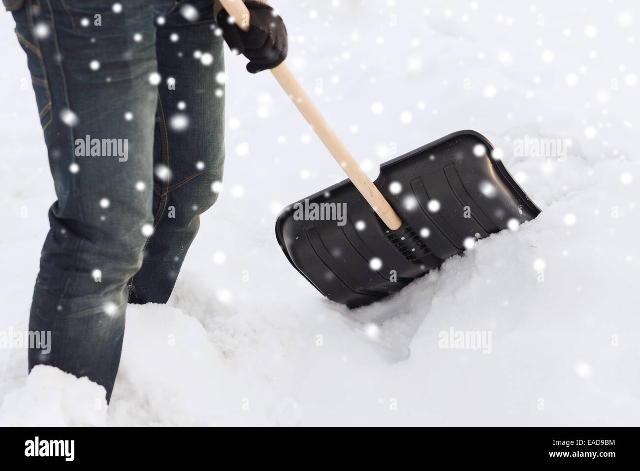 closeup of man digging snow with shovel Stock Photo - Alamy