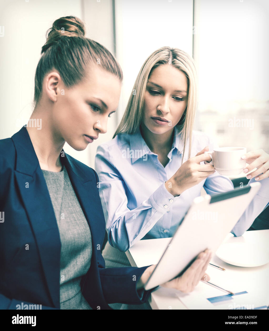 business team with tablet pc having discussion Stock Photo - Alamy