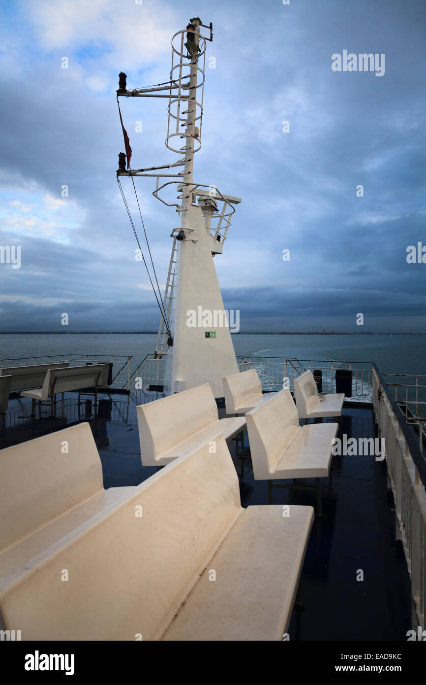 Unoccupied upper deck seats on ferry with ships mast and hoop vertical ...
