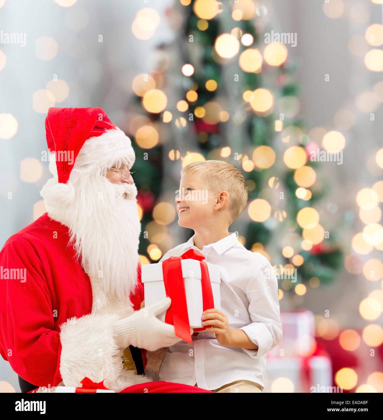 smiling little boy with santa claus and gifts Stock Photo - Alamy