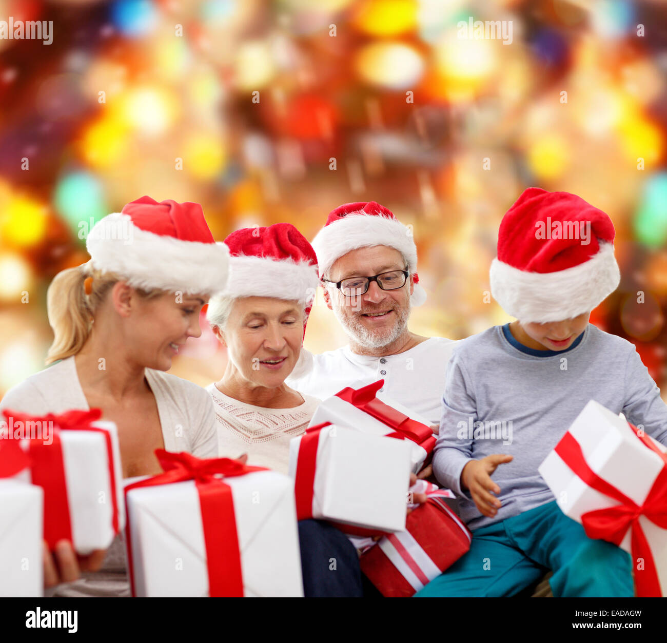 happy family in santa helper hats with gift boxes Stock Photo - Alamy