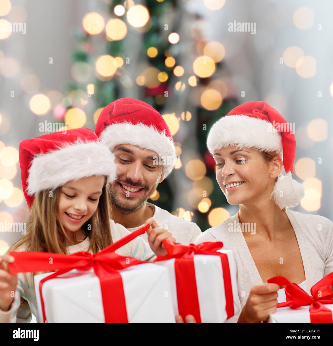 happy family in santa helper hats with gift boxes Stock Photo - Alamy