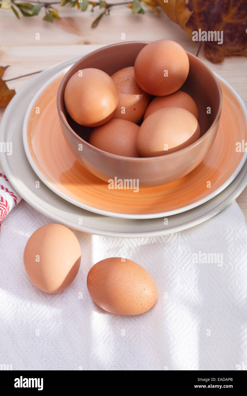 chicken eggs in ceramic dishes on white fabric Stock Photo - Alamy